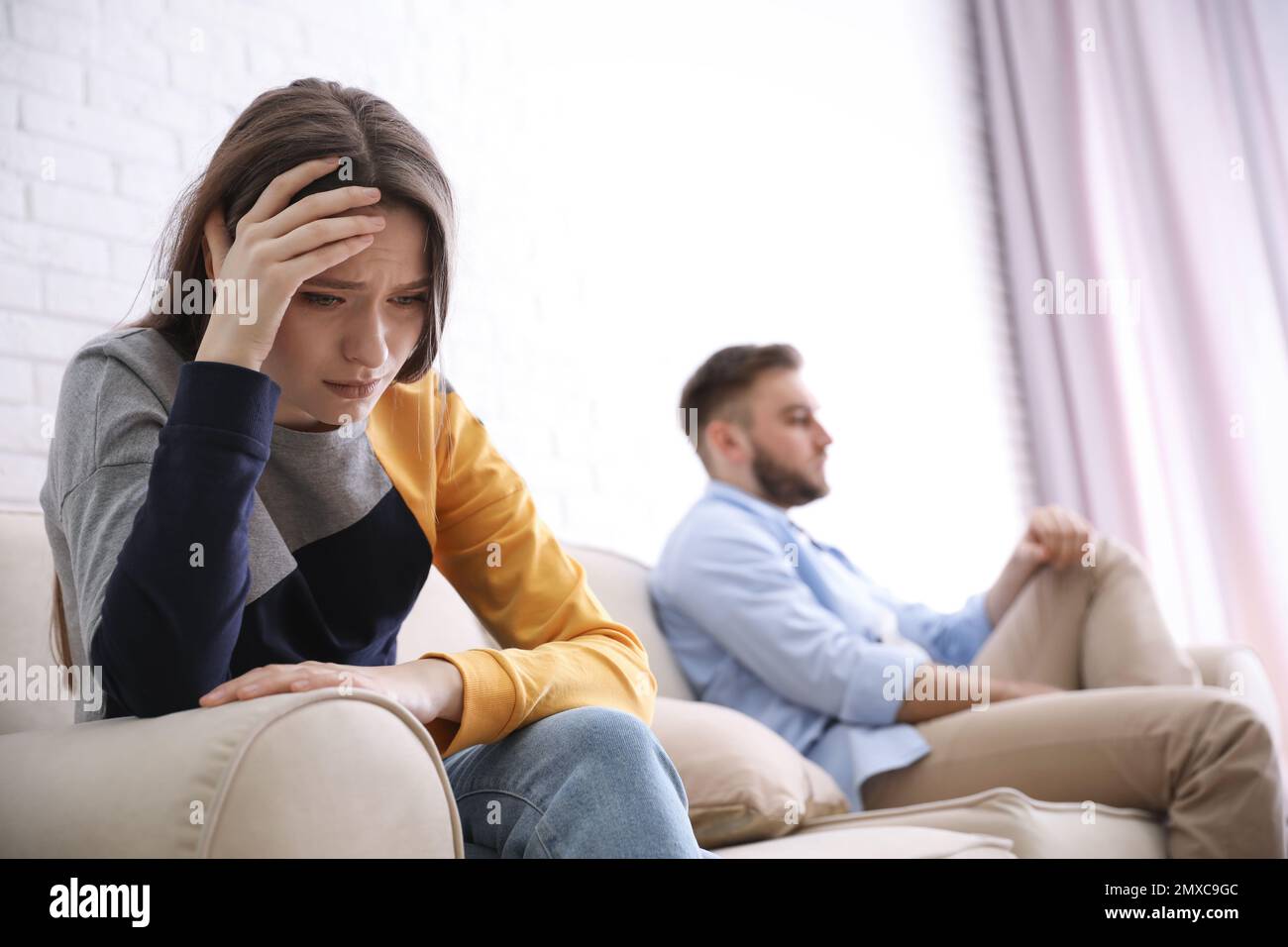 Unhappy couple with problems in relationship at home, focus on woman ...