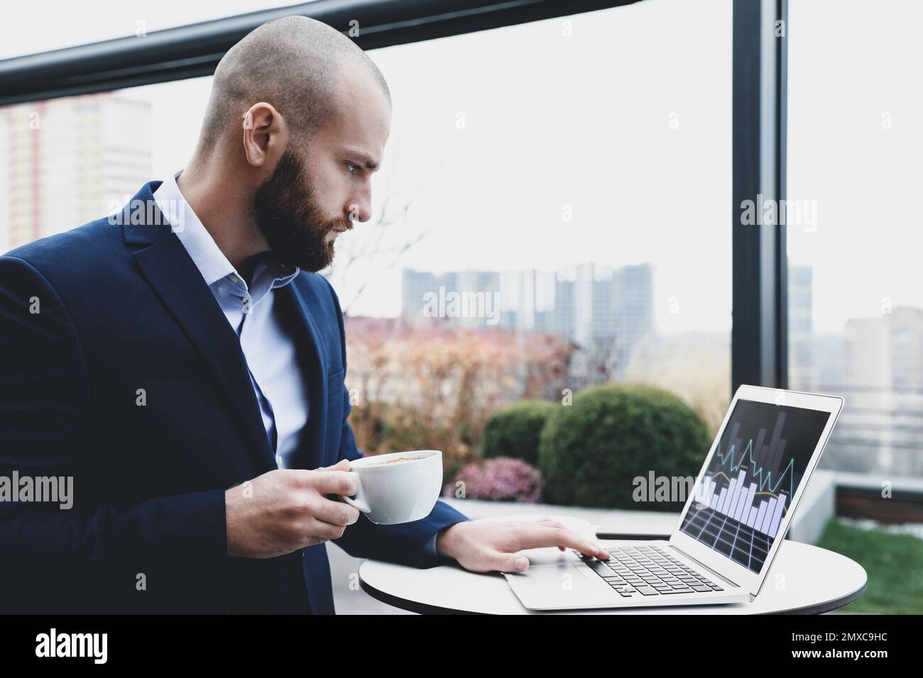 Broker with laptop and coffee in office. Forex trading Stock Photo - Alamy