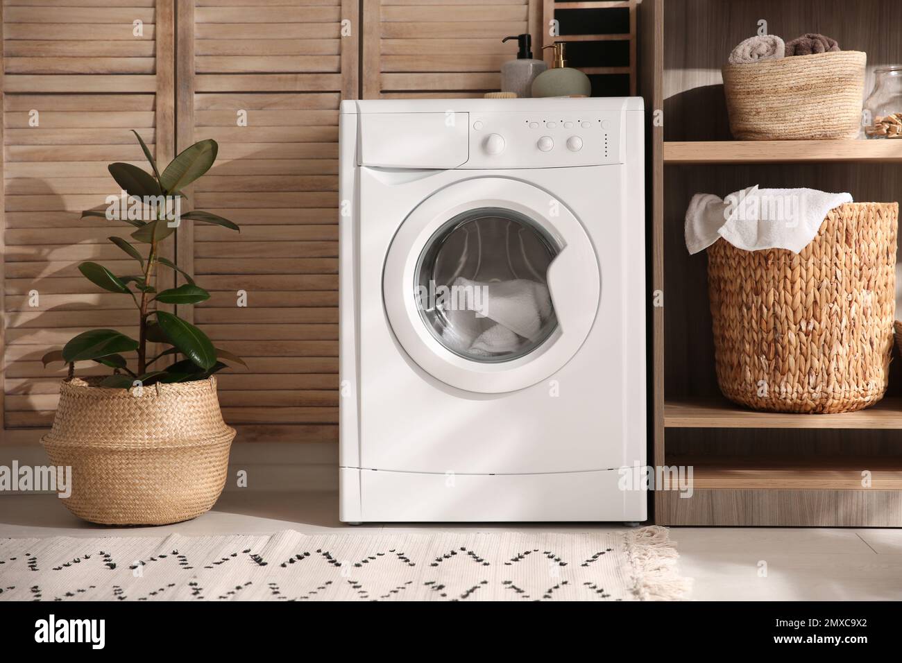 Modern washing machine and shelving unit in laundry room interior Stock ...