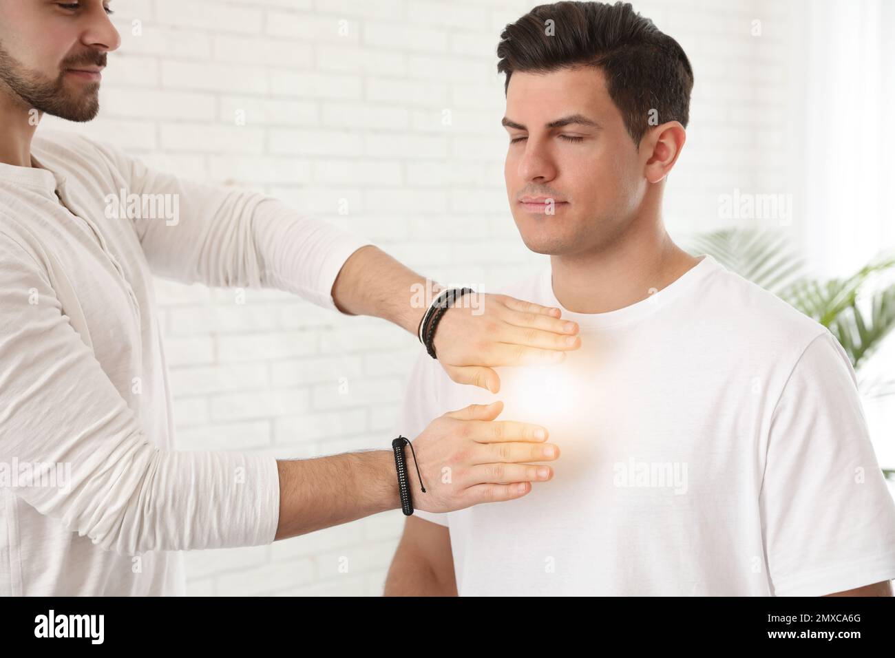 Man during healing session in therapy room Stock Photo - Alamy