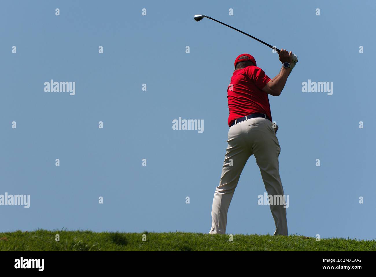 Man playing golf on beautiful sunny green golf course, golfer shooting ...