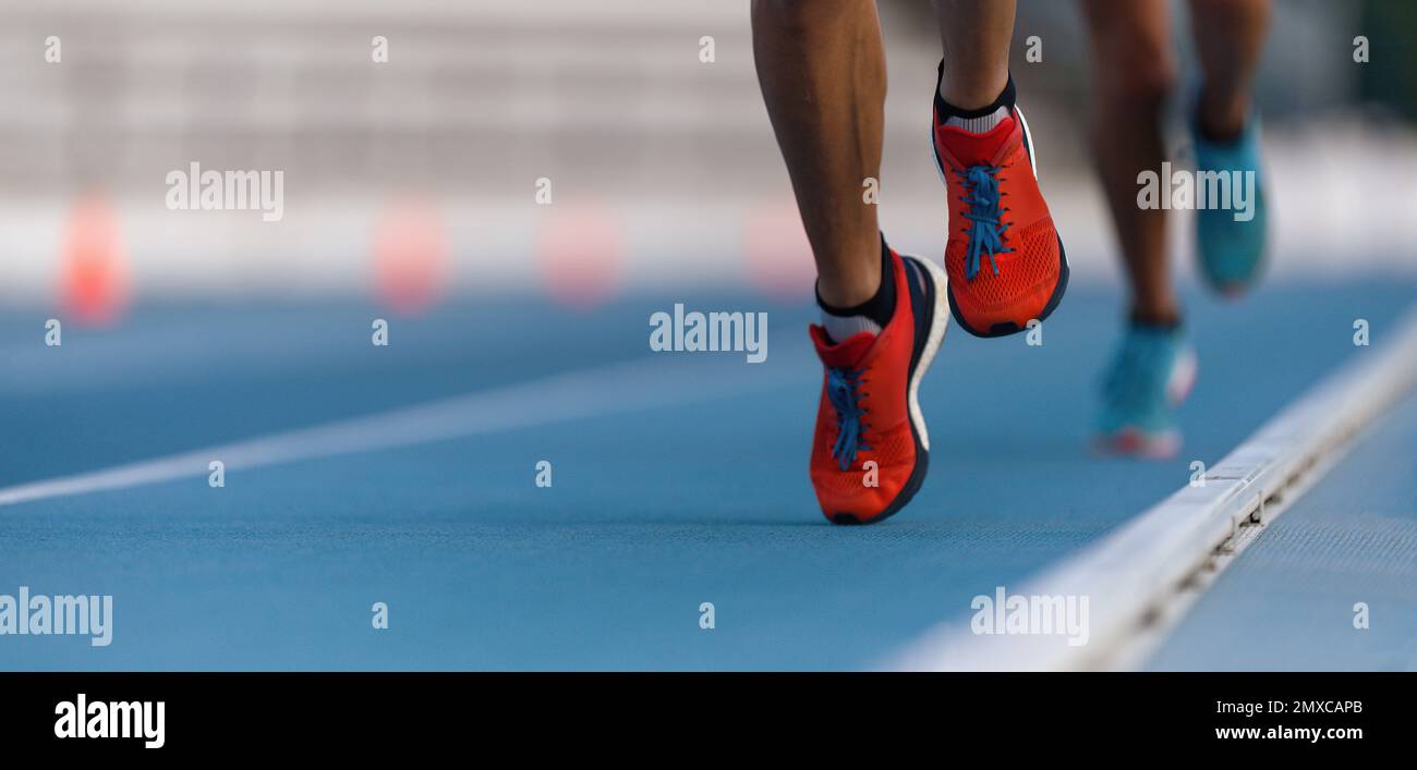 Athletes sprinters run speed on track of stadium Stock Photo - Alamy