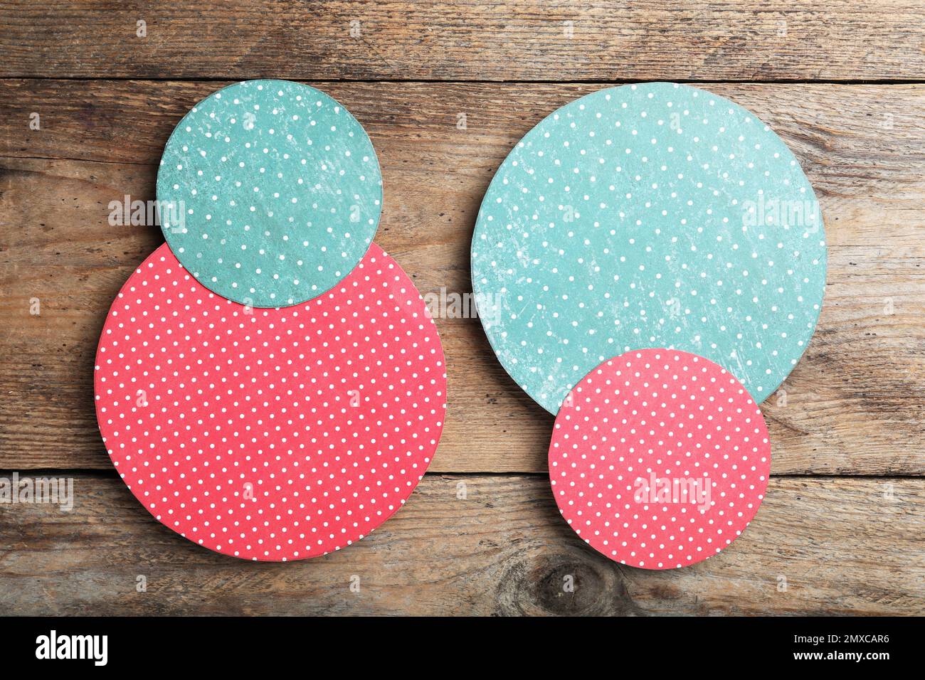 Big and small colorful paper circles on wooden background, flat lay ...