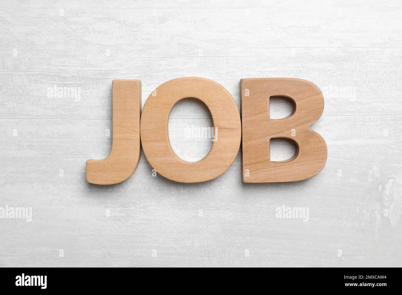Word JOB made with wooden letters on white background, flat lay. Career ...