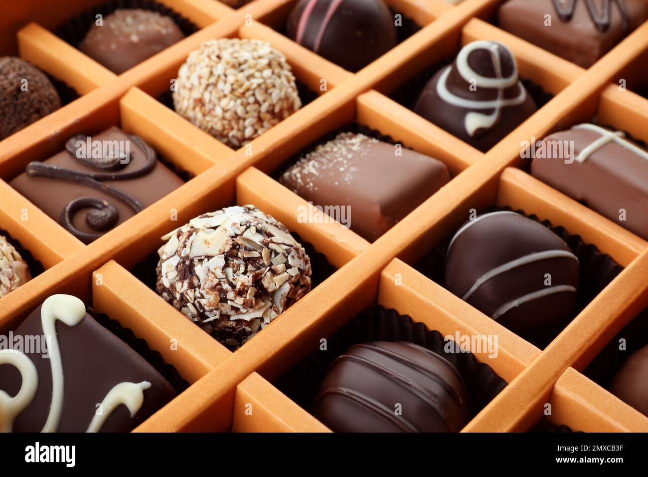 Box with different chocolate candies as background, closeup Stock Photo ...