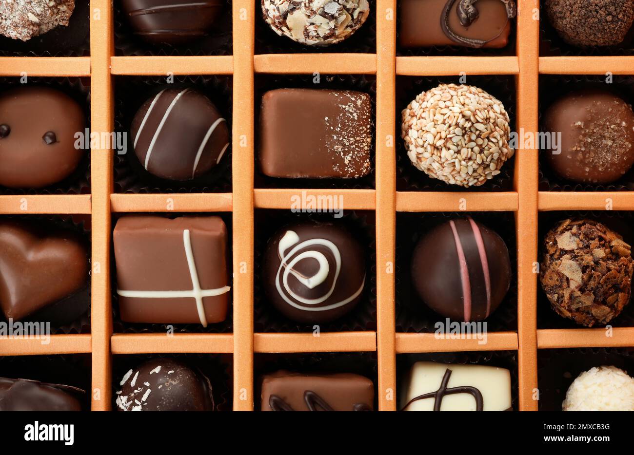 Box with different chocolate candies as background, top view Stock ...