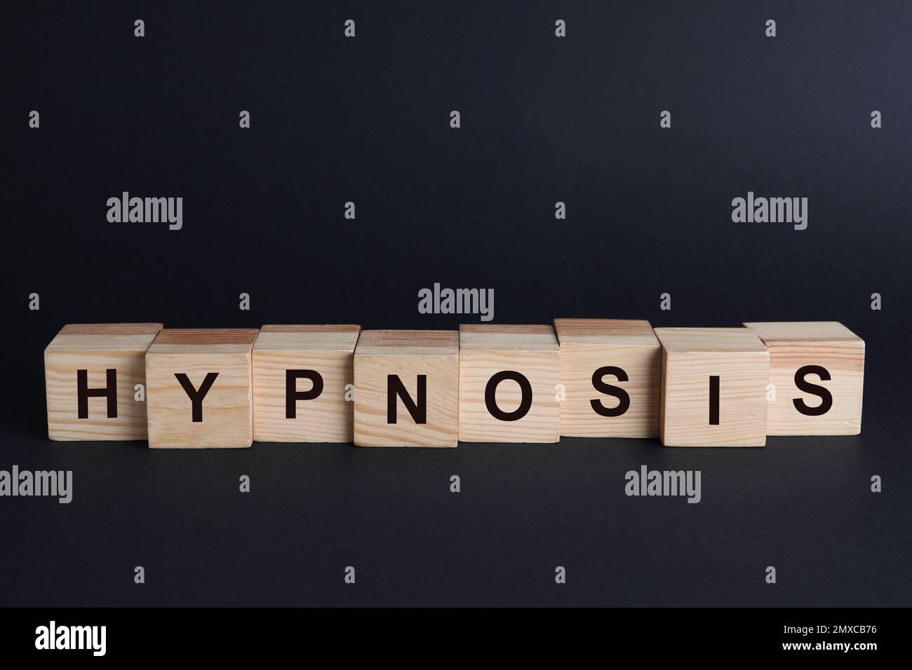 Wooden blocks with word HYPNOSIS on black background Stock Photo - Alamy
