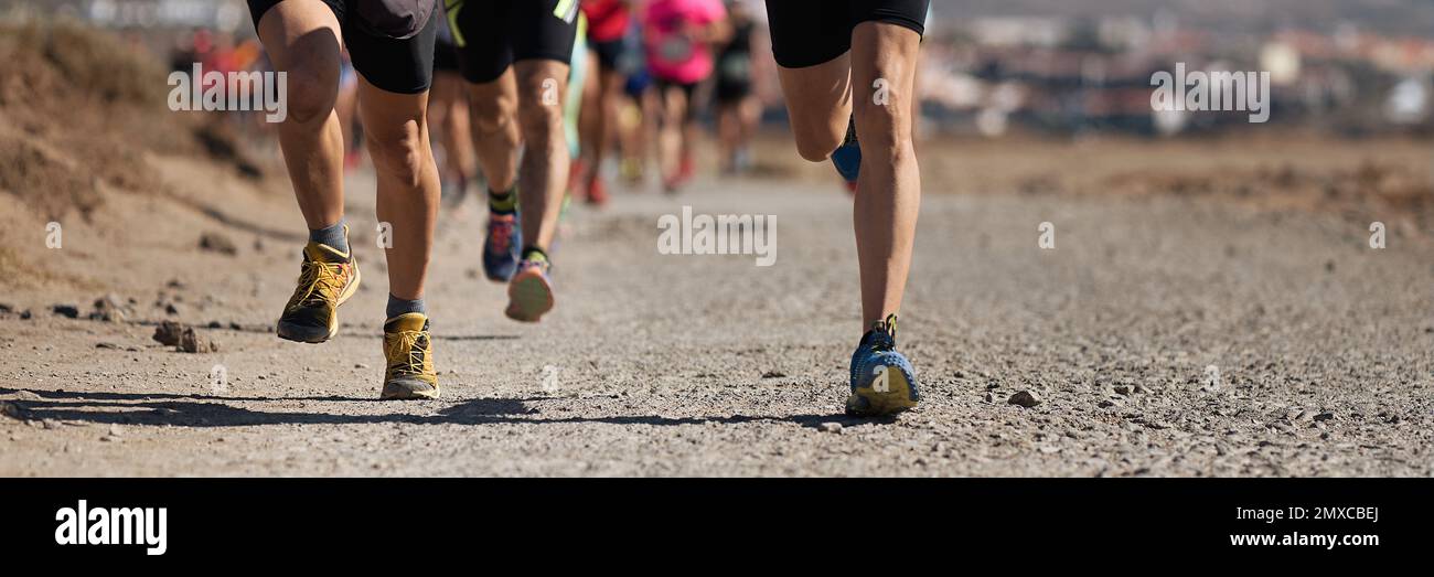 Runners running shoes on trail run. Ultra running athletes legs close ...