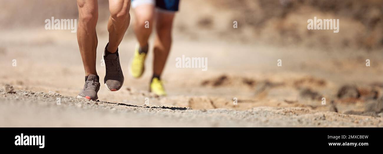 Runners running shoes on trail run. Ultra running athletes legs close ...
