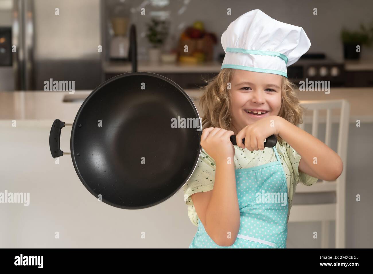Child chef cook is learning how to make a cake in the home kitchen ...