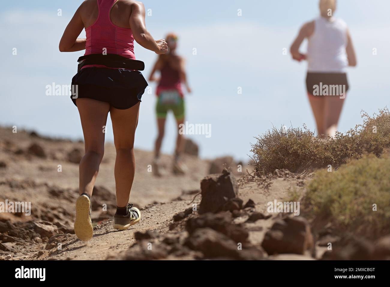 Runners running shoes on trail run. Ultra running athletes legs close ...