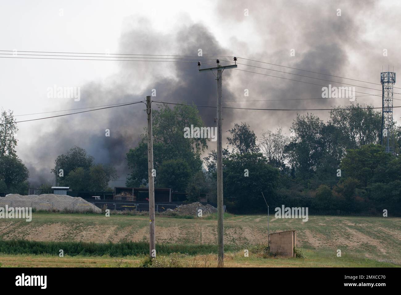 Smoke rising from a serious fire on a small industrial estate set in ...