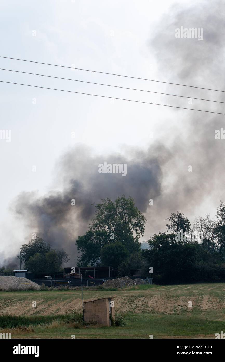 Smoke rising from a serious fire on a small industrial estate set in ...