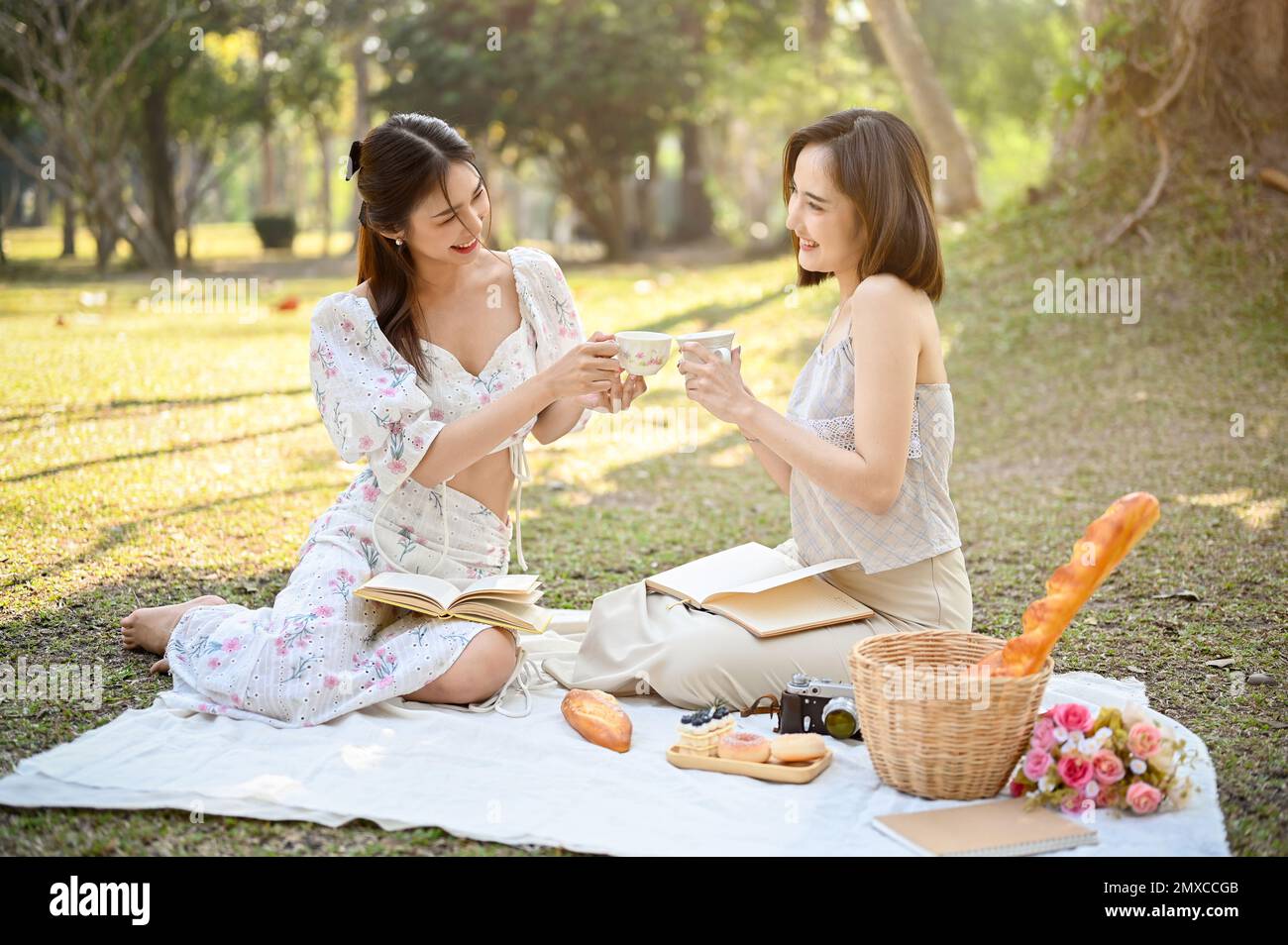 Two attractive and charming millennial Asian women are enjoying an ...