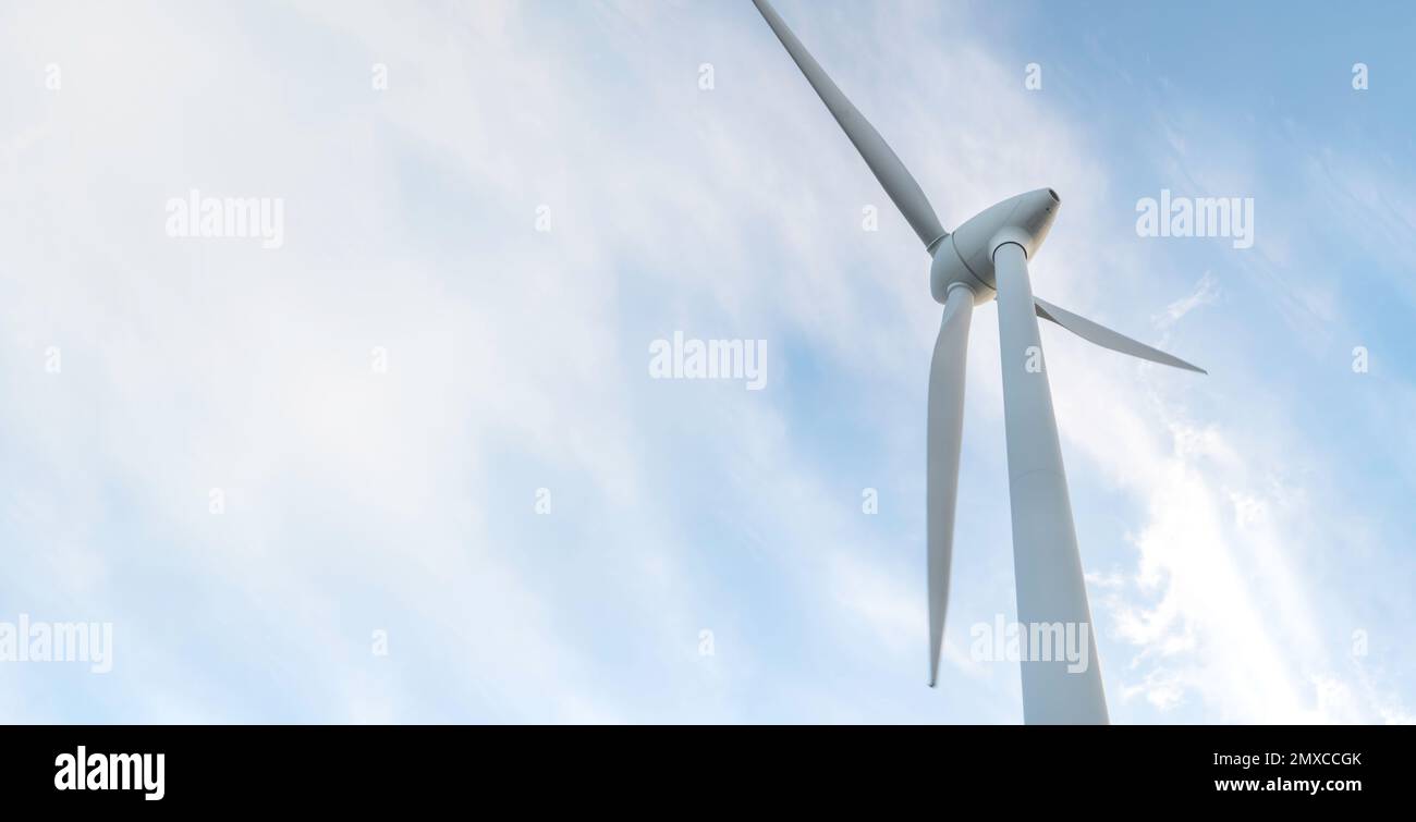 blurred banner windmill farm or wind park, with high wind turbines for ...
