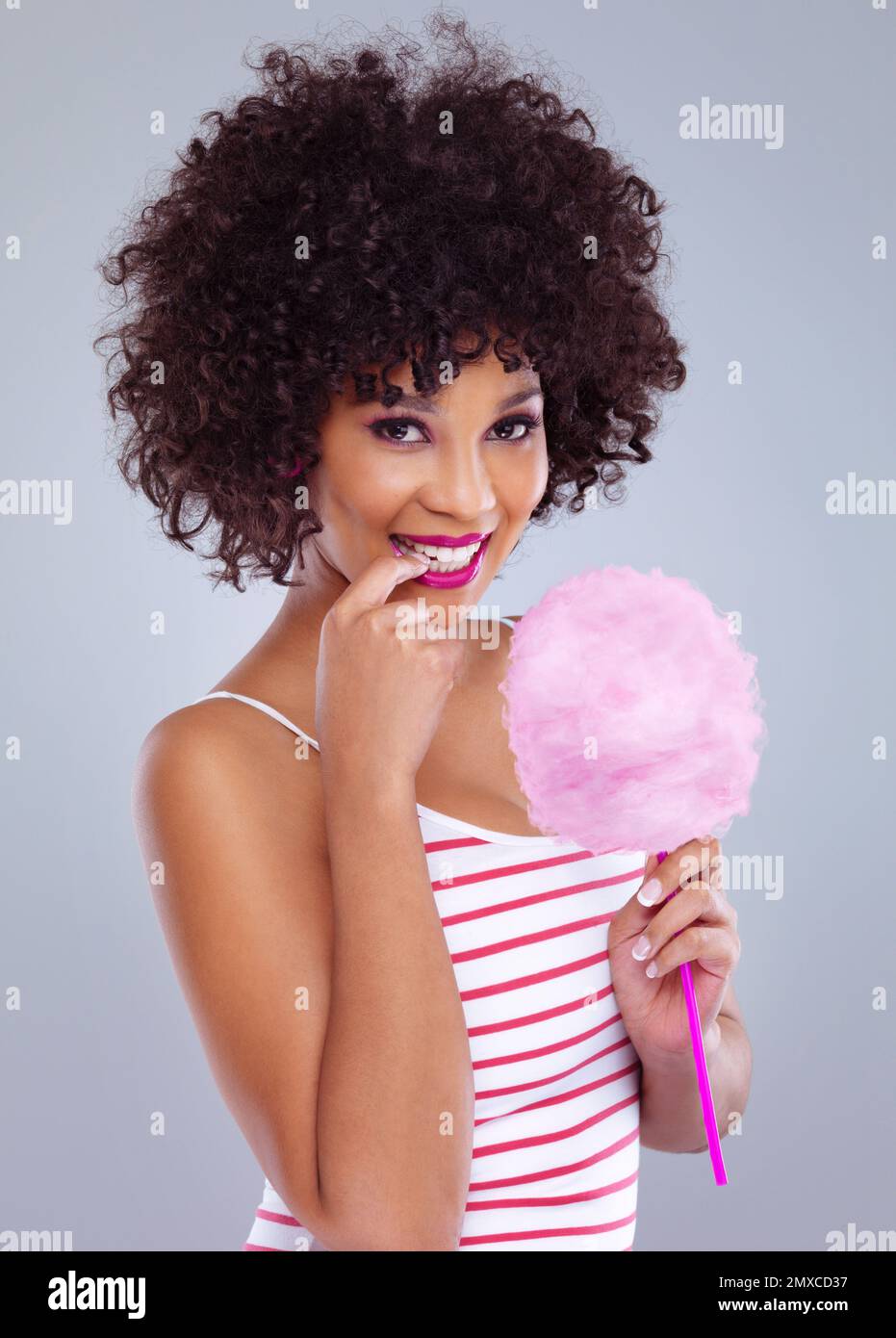 Shes candy floss cute. Studio shot of a beautiful young woman against a ...