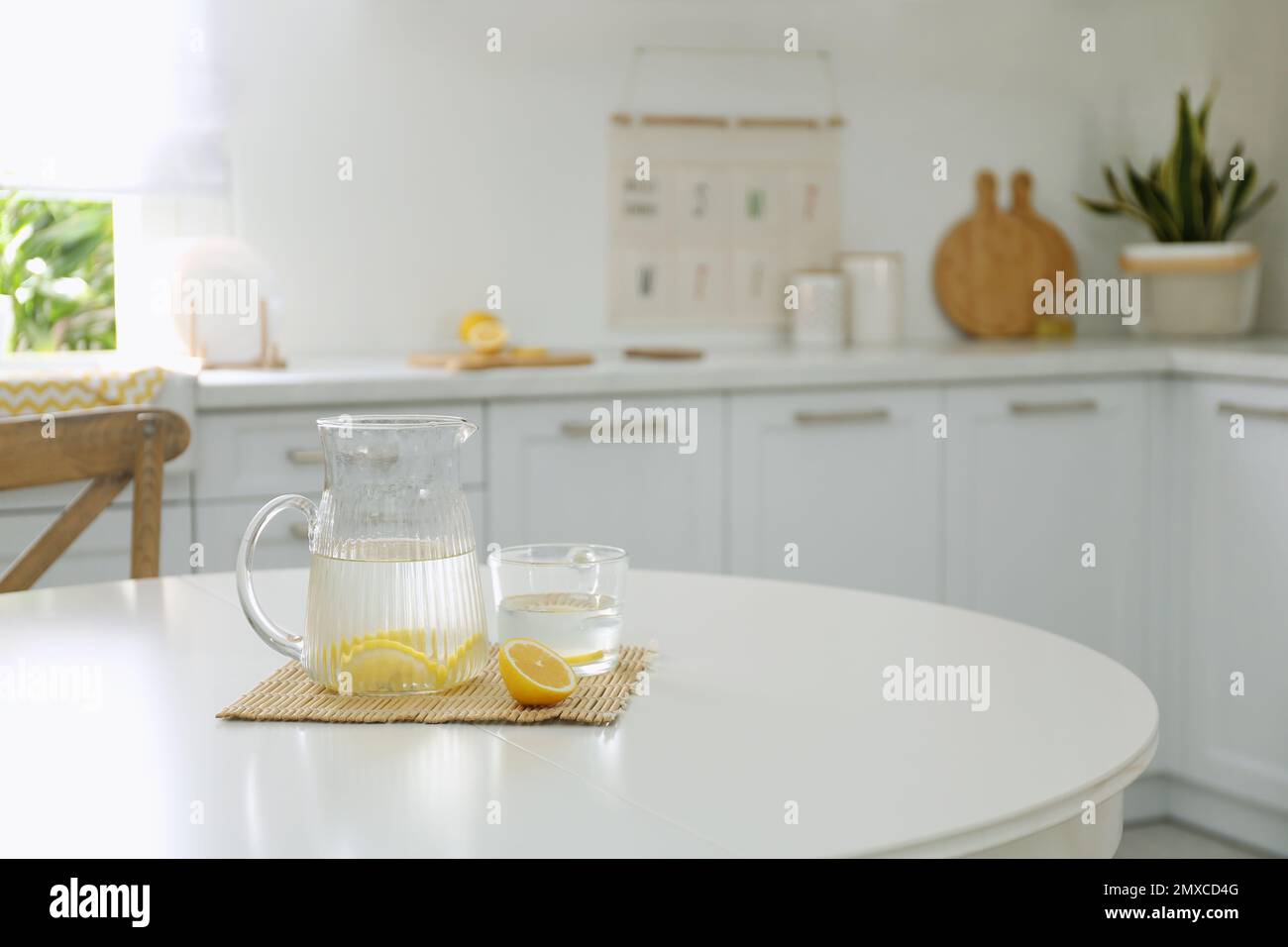 Lemonade on white table in modern kitchen. Interior design Stock Photo ...