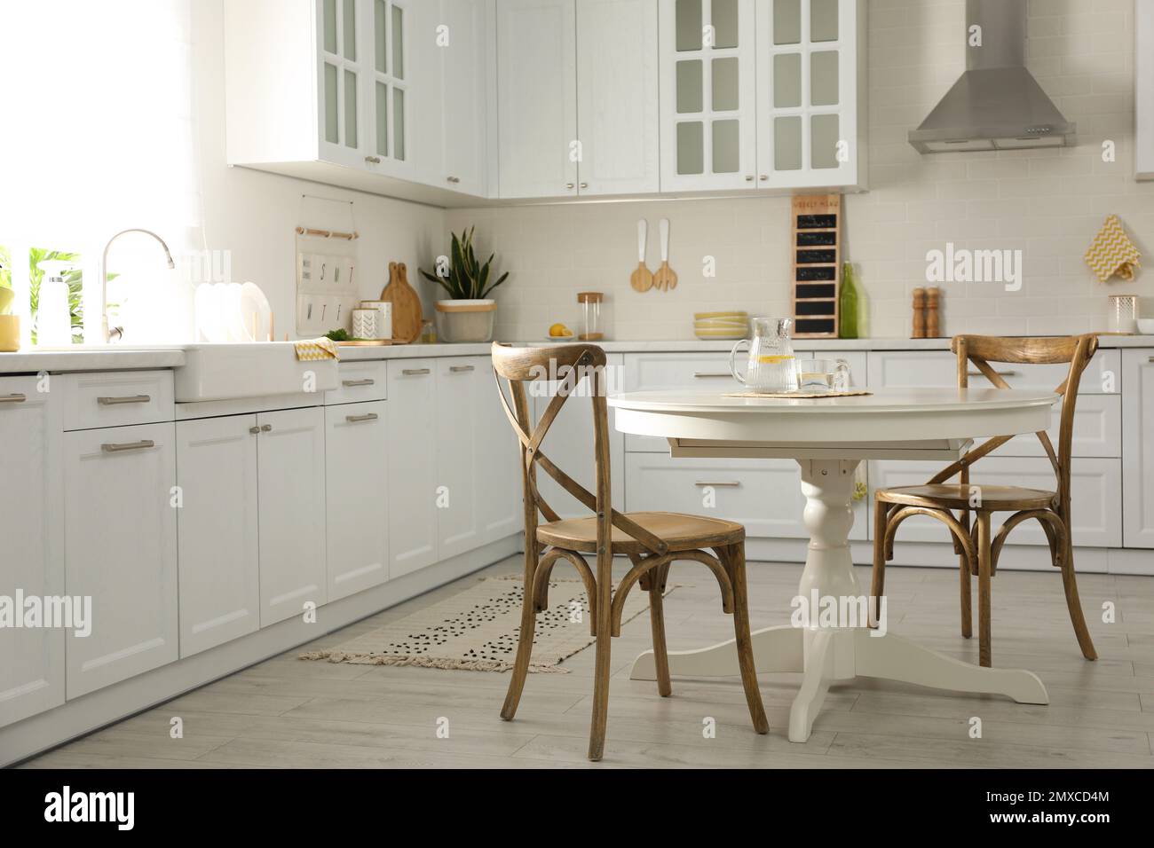 Elegant kitchen interior design with white round table Stock Photo - Alamy