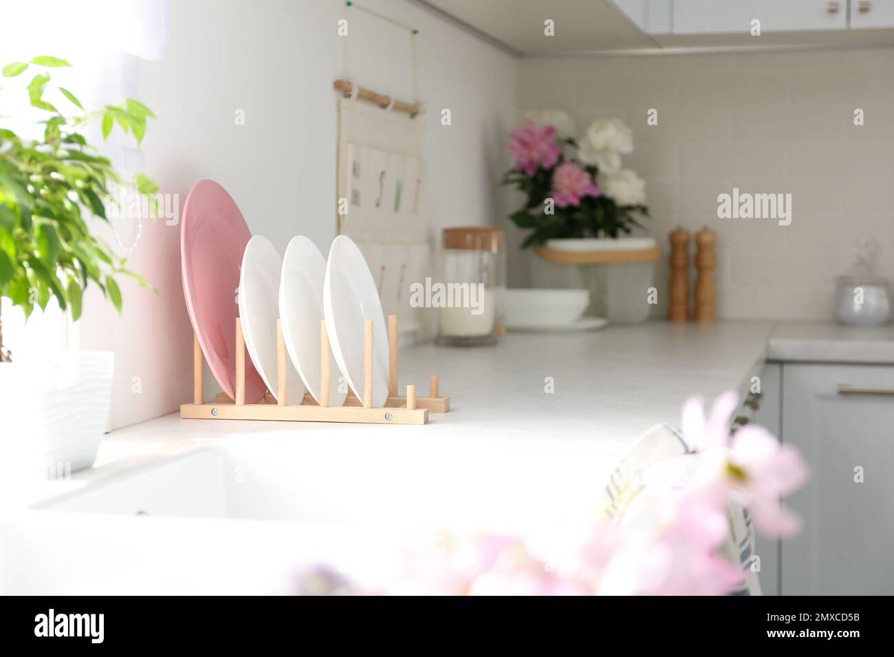 Clean plates on white countertop in modern kitchen. Interior design ...