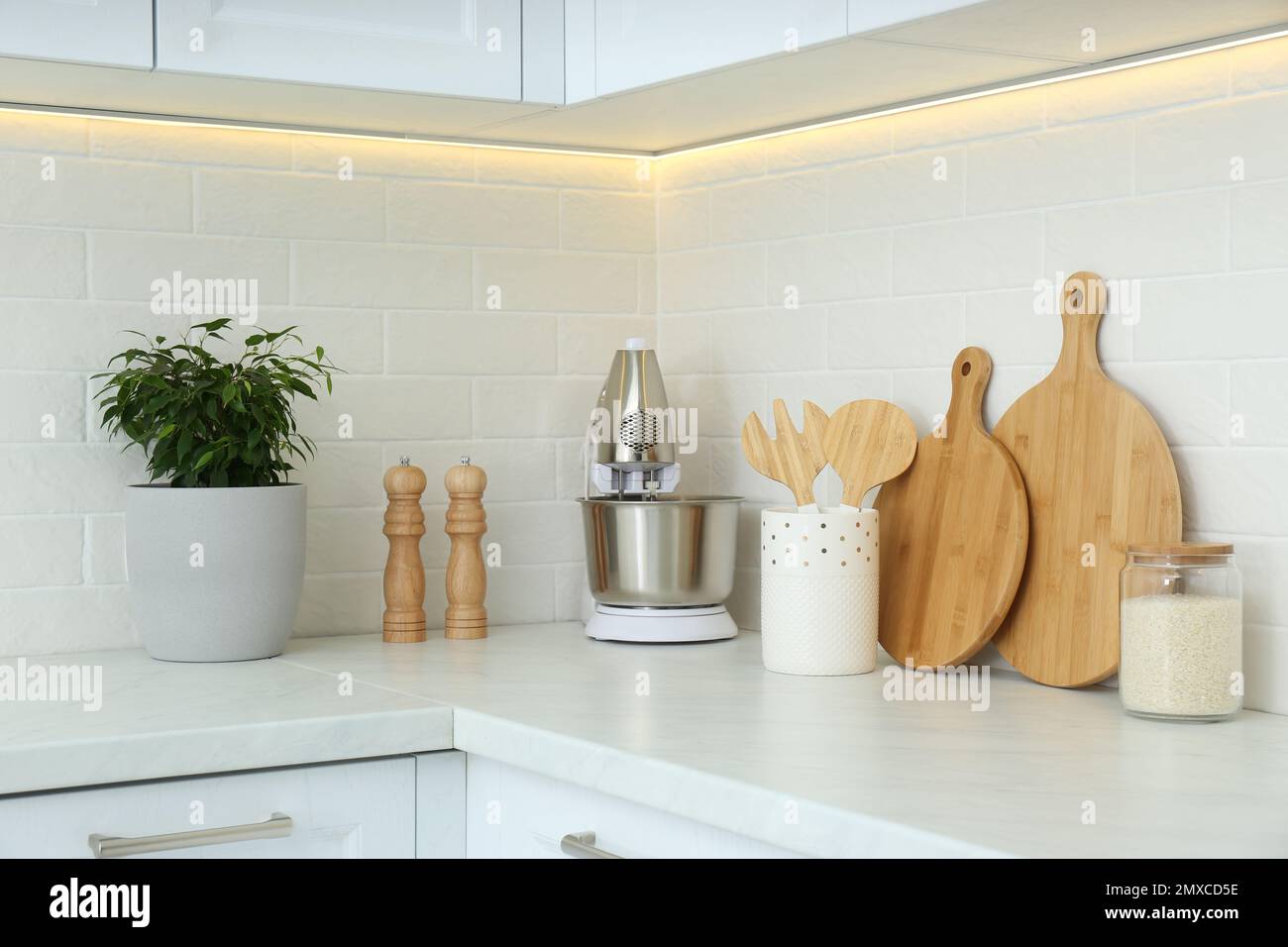 Different kitchen items and houseplant on countertop indoors Stock ...