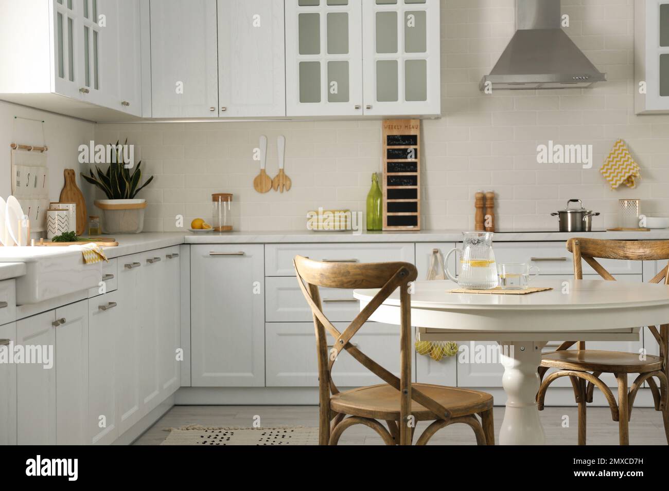 Elegant kitchen interior design with white round table Stock Photo - Alamy