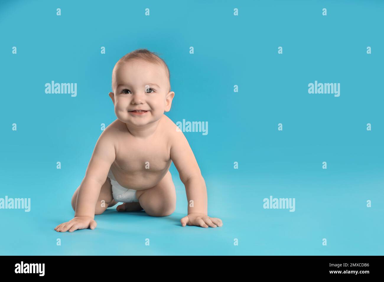 Cute little baby in diaper on light blue background. Space for text ...