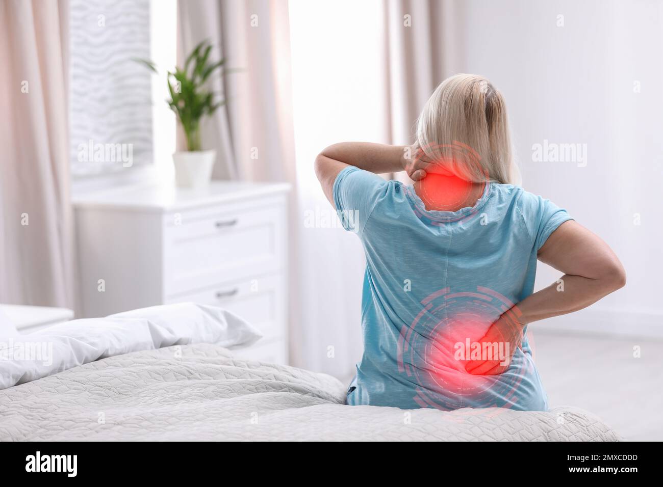 Woman suffering from back pain after sleeping on uncomfortable mattress ...