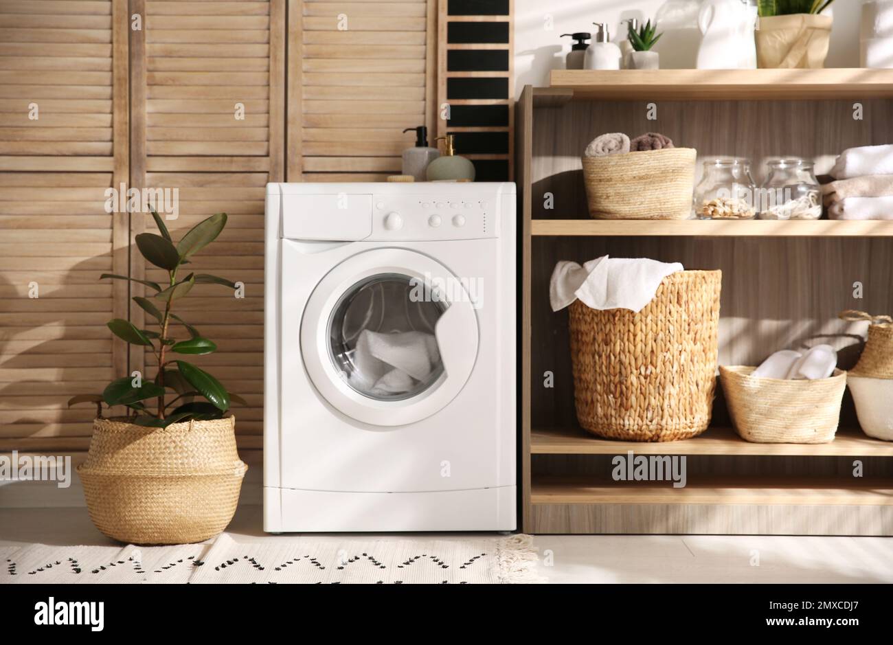 Modern washing machine and shelving unit in laundry room interior Stock ...