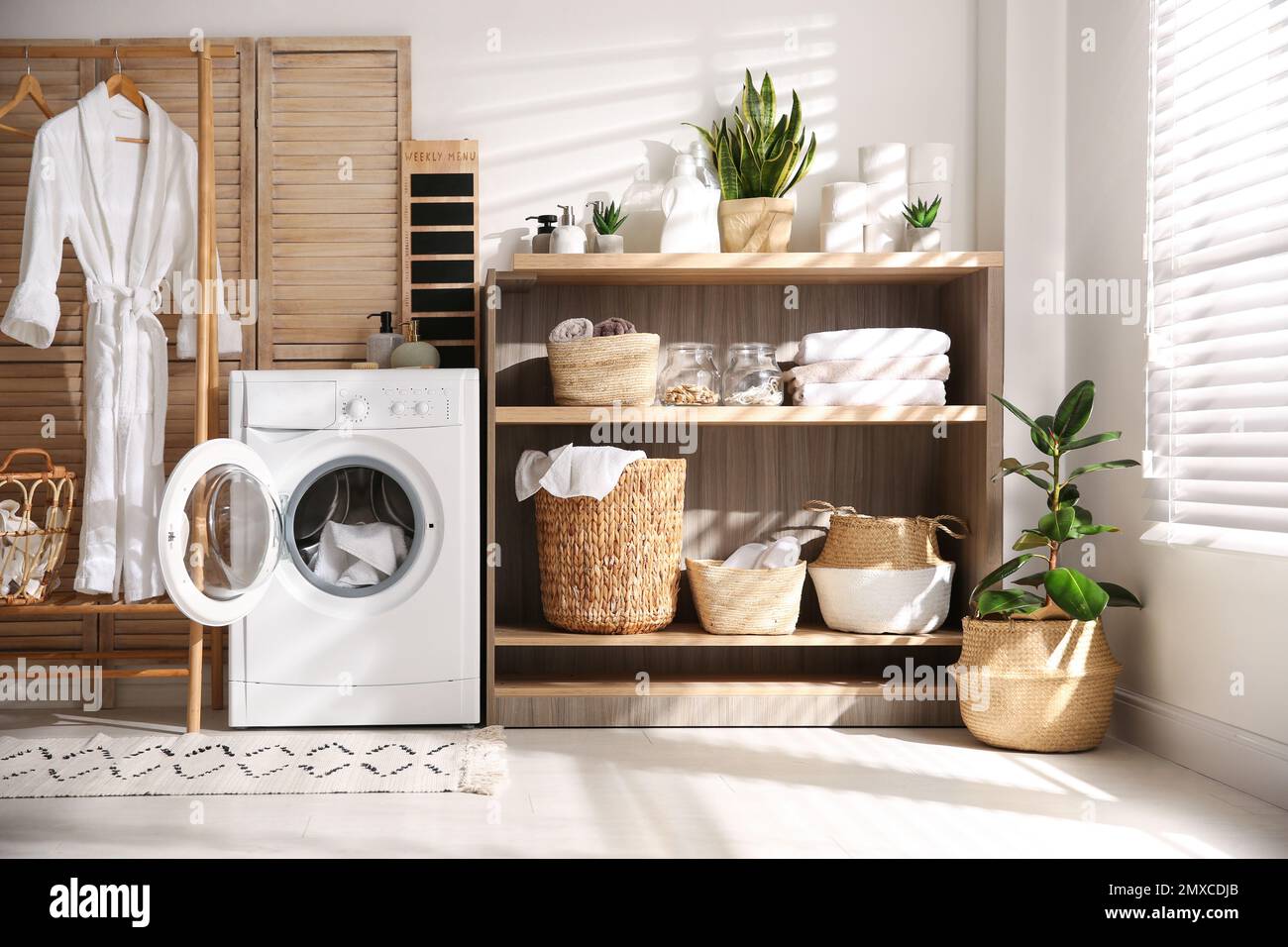Modern washing machine and shelving unit in laundry room interior Stock ...