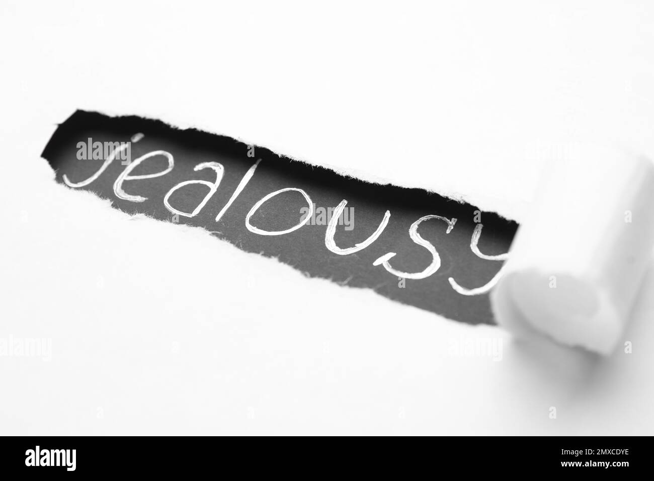 Word JEALOUSY under ripped paper as background Stock Photo - Alamy