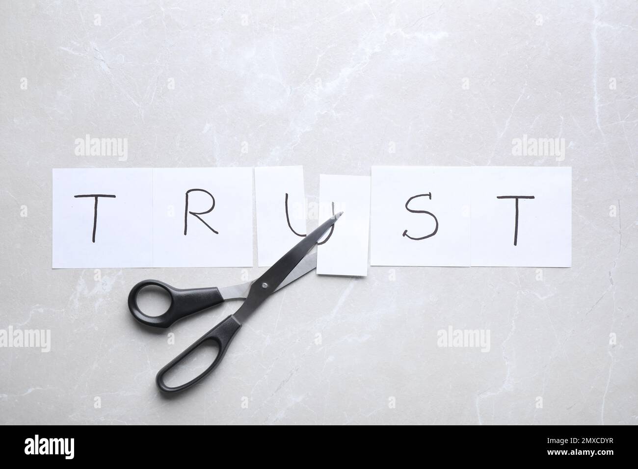 Paper notes with word TRUST and scissors on marble background, flat lay ...