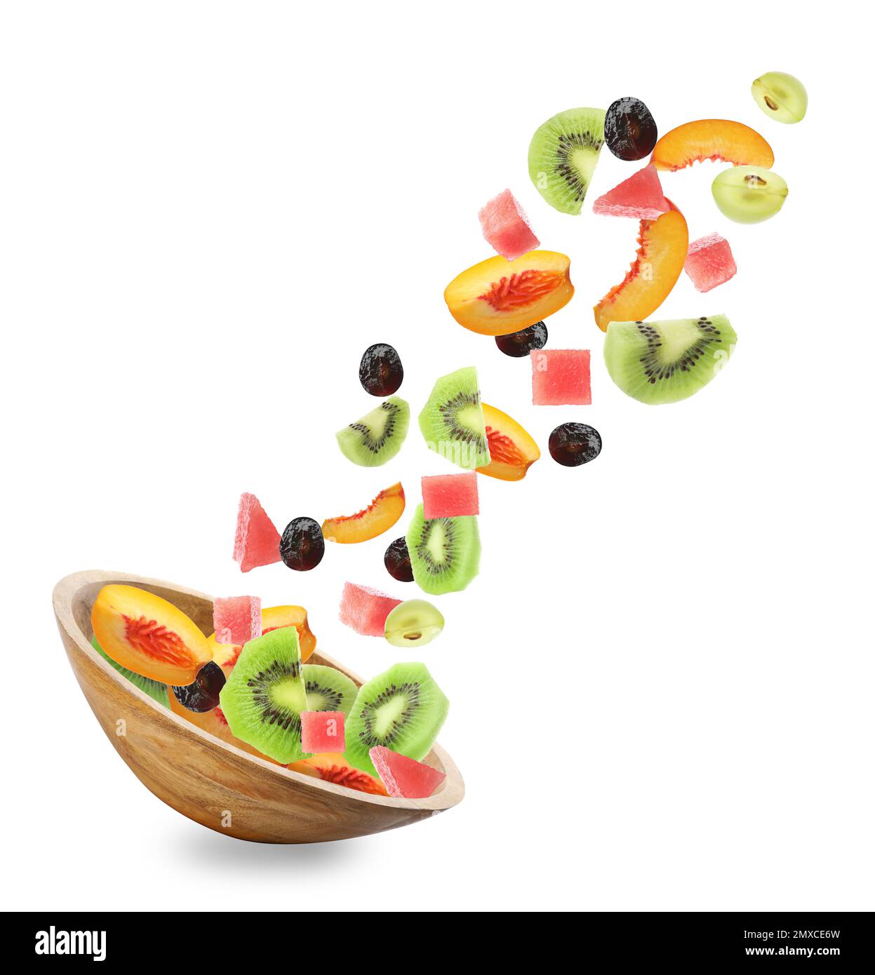 Fresh tasty fruits and berries falling into bowl on white background ...