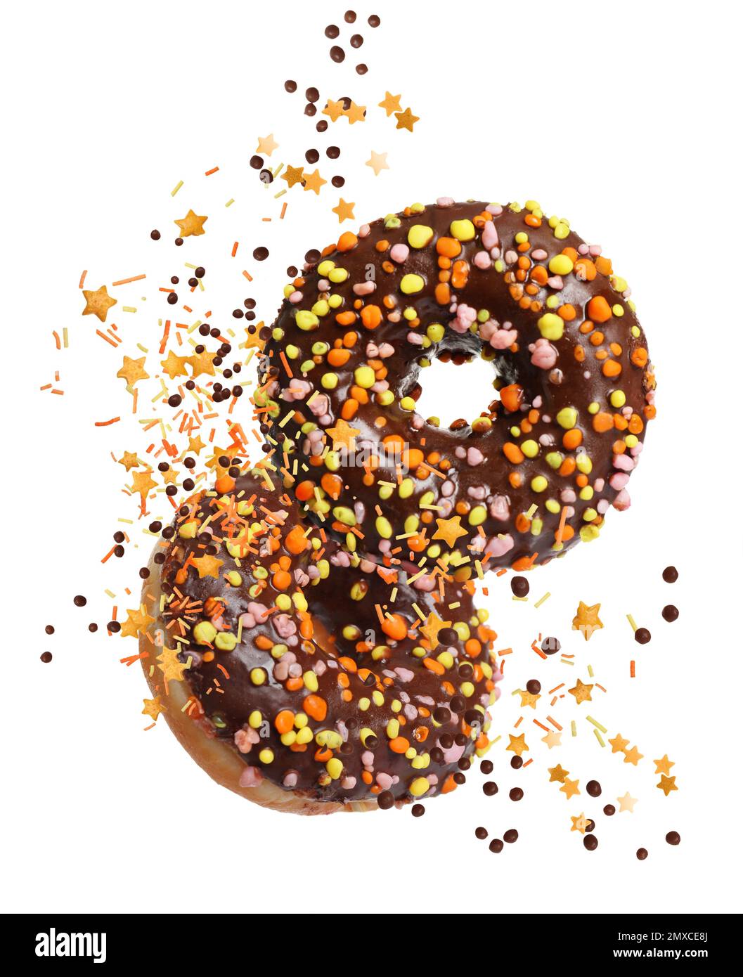 Sweet delicious donuts falling on white background Stock Photo - Alamy