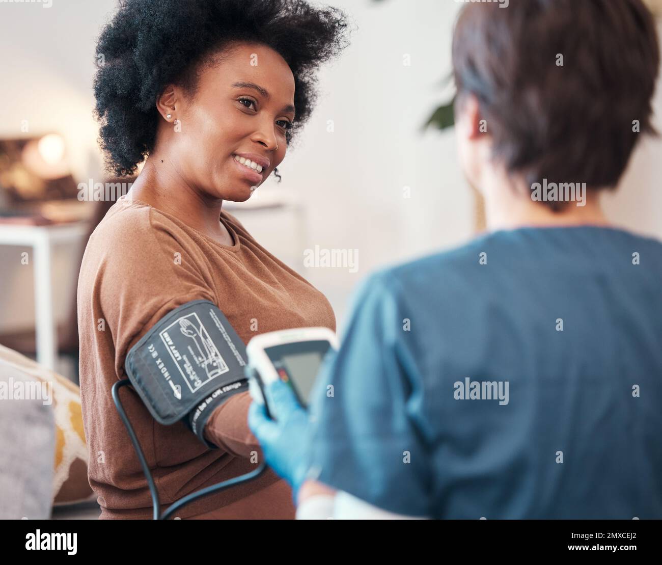 Black woman, healthcare and blood pressure checkup with caregiver ...