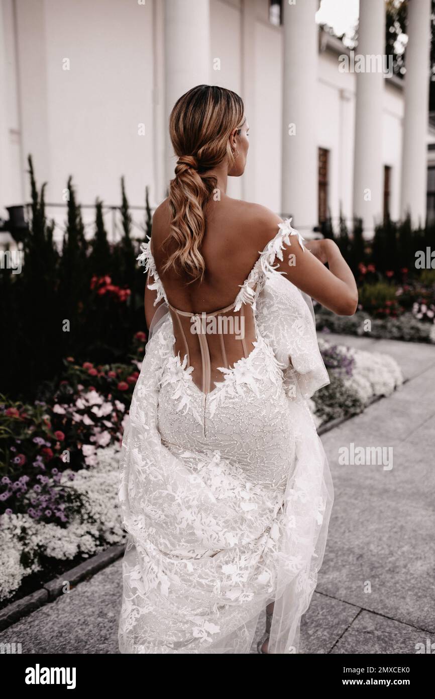 A back view of a bride wearing an elegant white wedding dress Stock ...