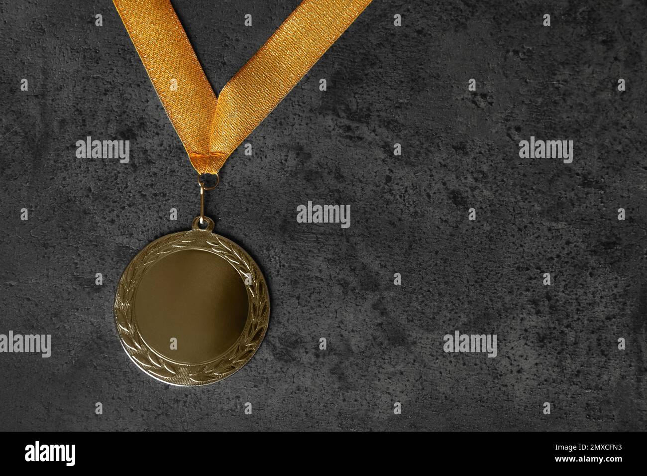 Gold medal on grey stone background, top view. Space for design Stock ...
