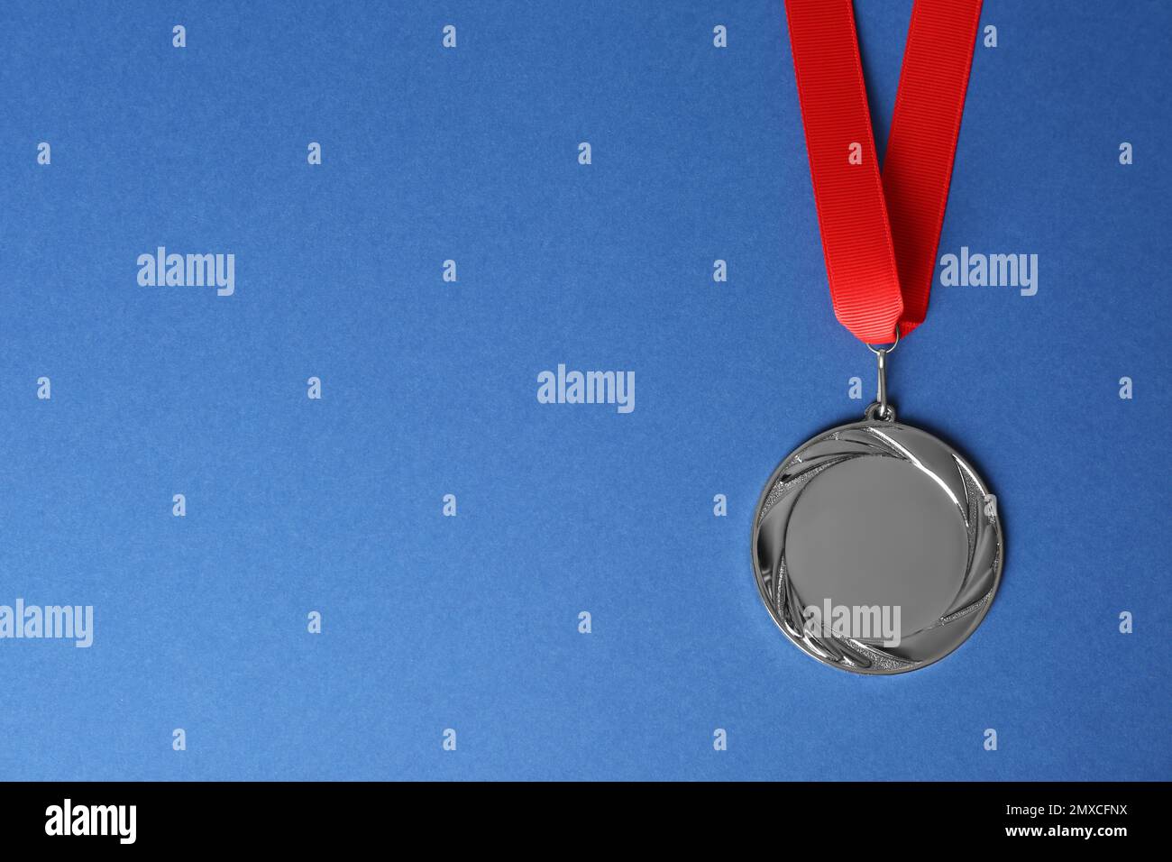 Silver medal on blue background, top view. Space for design Stock Photo ...