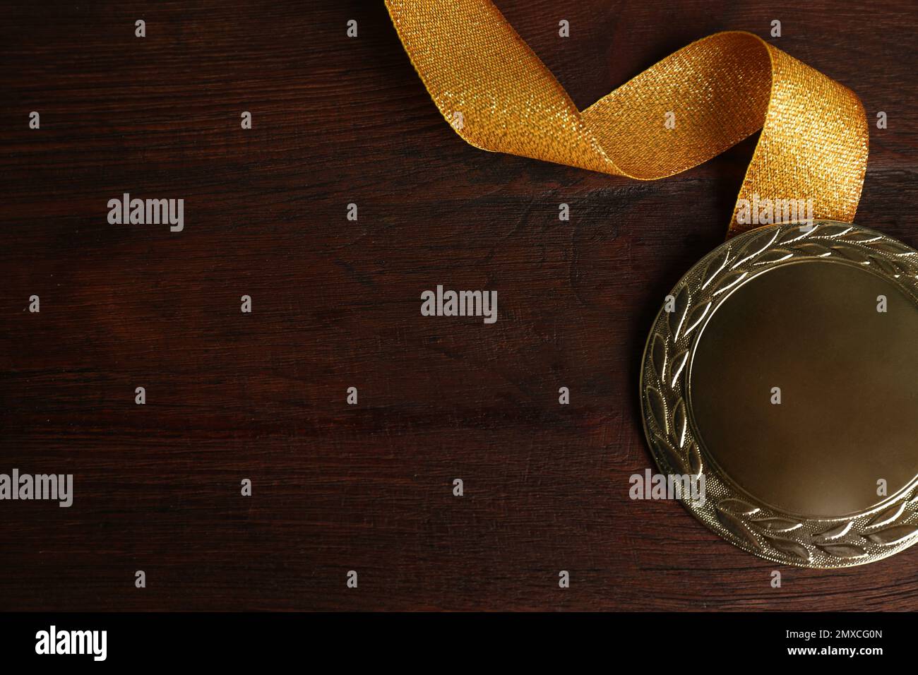 Gold medal with ribbon on wooden background, flat lay. Space for design ...
