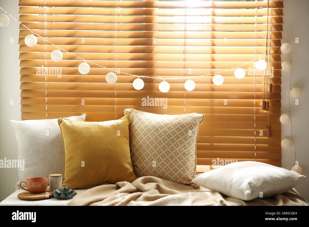 Comfortable place for rest with cushions on window sill Stock Photo - Alamy