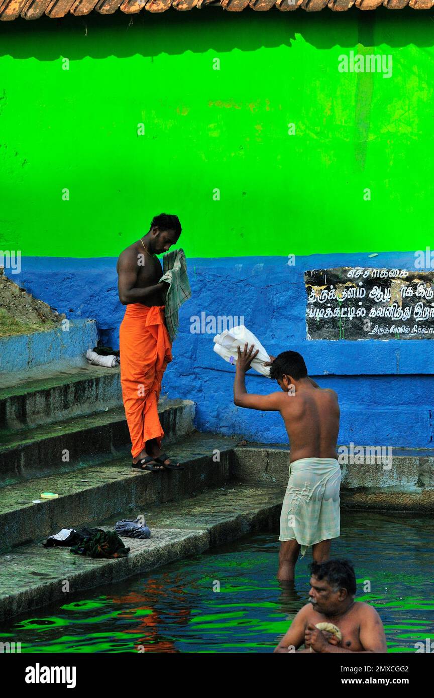 People bathing and washing cloth in water tank at Suchindram state ...