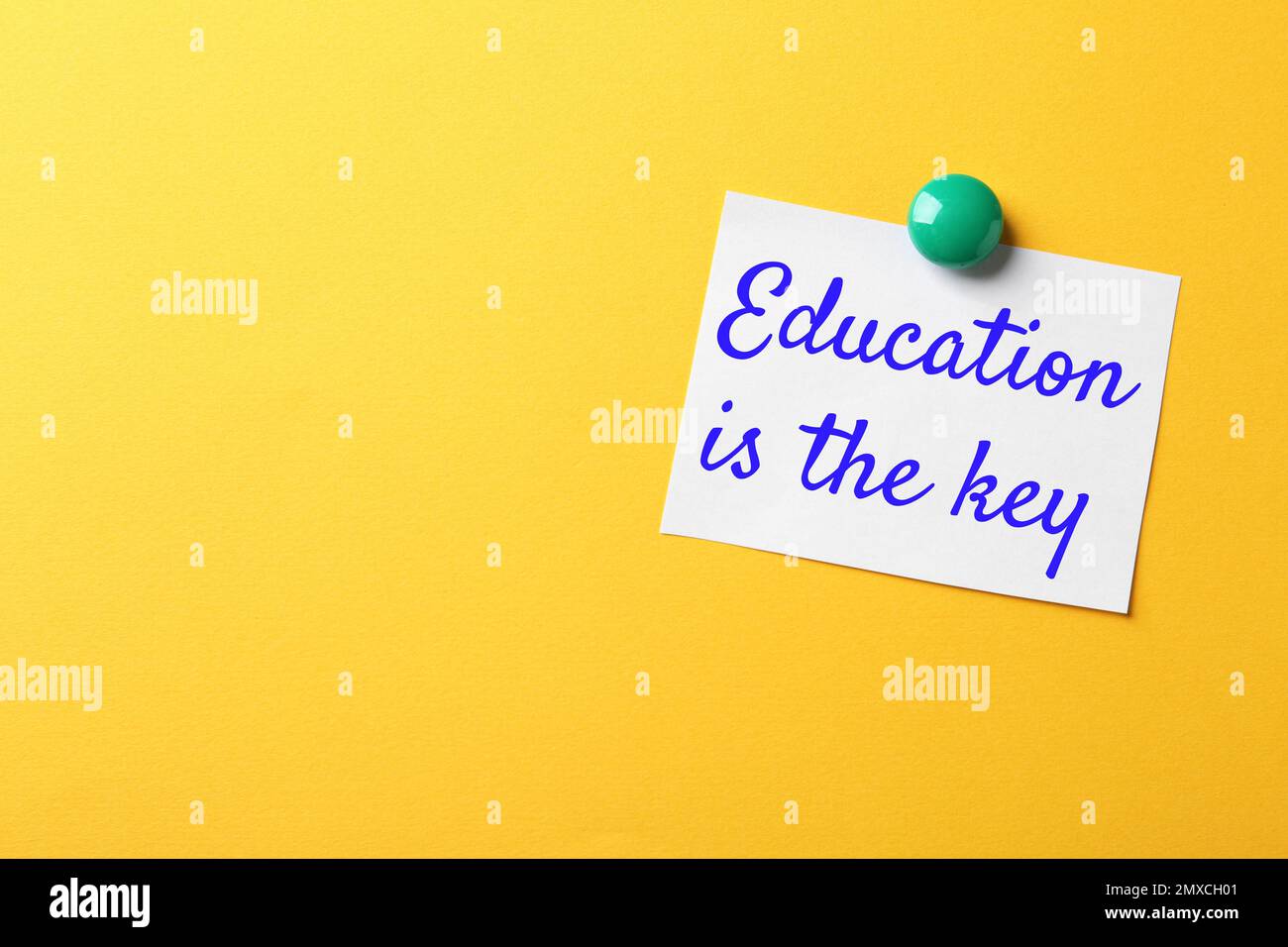 Paper note with text Education is the key on yellow background. Adult ...