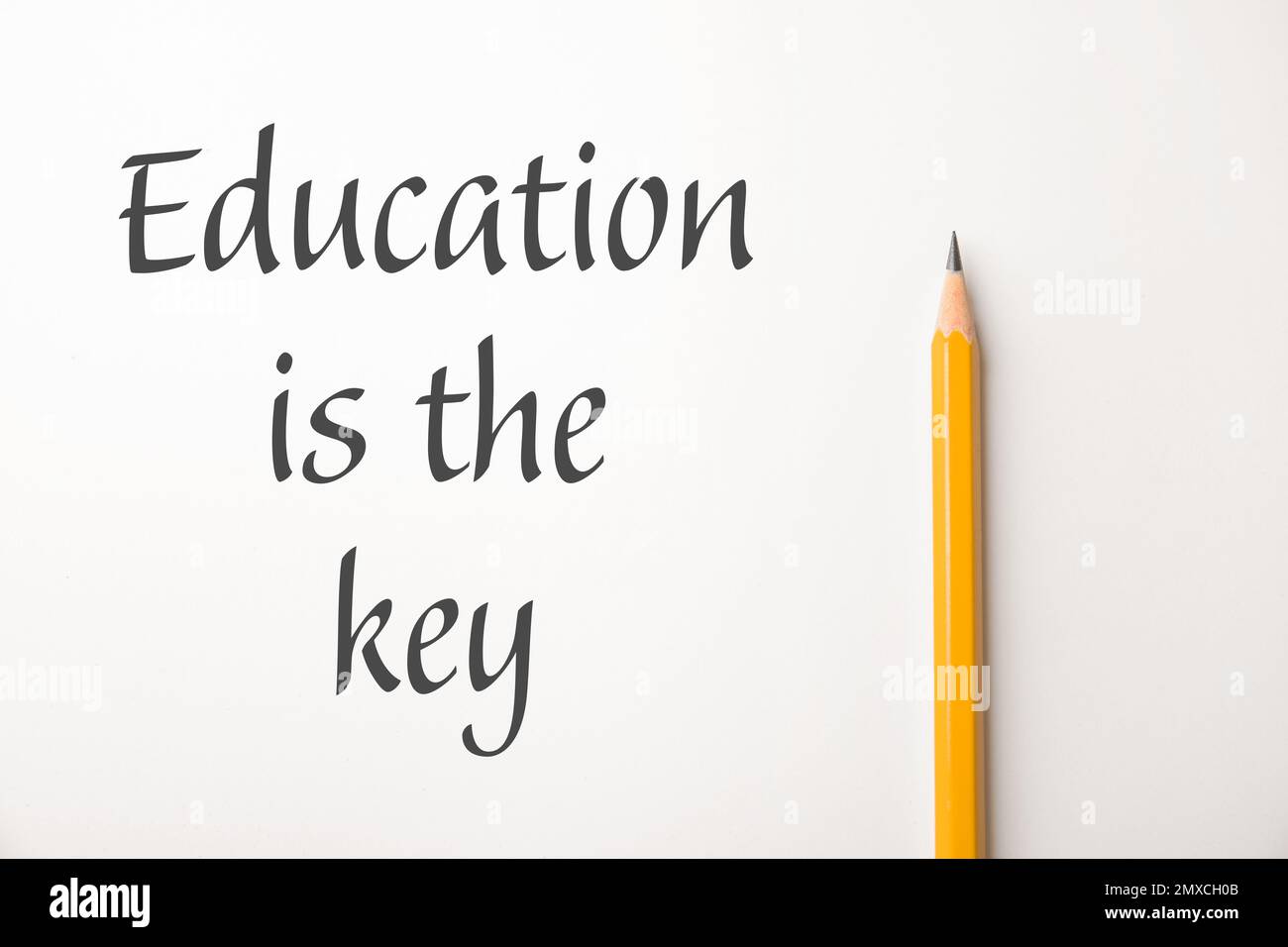Phrase Education is the key and sharp pencil on white background, top ...