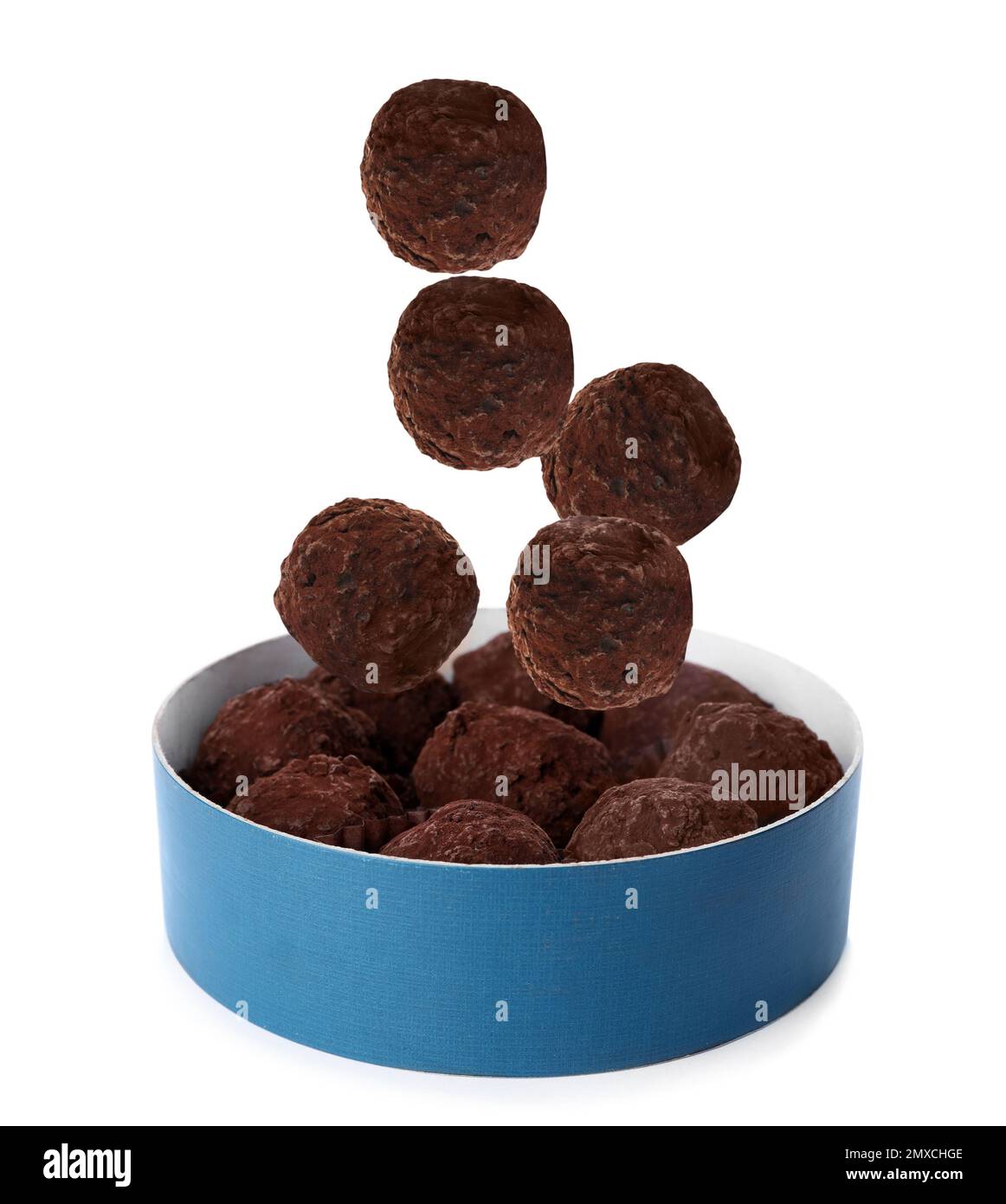 Chocolate candies falling into box on white background Stock Photo - Alamy