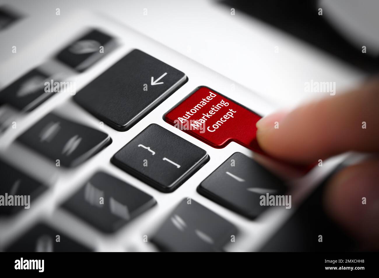 Woman pressing button with text AUTOMATED MARKETING CONCEPT on modern laptop keyboard, closeup ...