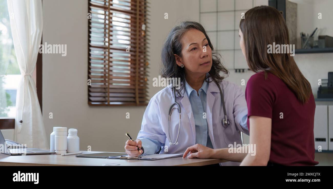 Senior Doctor and her patient. Doctor giving advice to a female patient ...