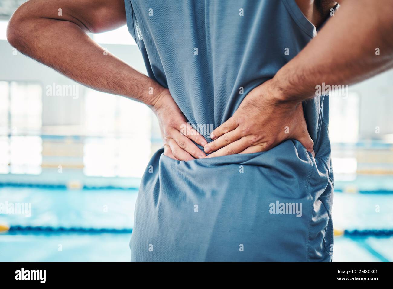 Back pain, sports and hands of man by swimming pool with injury, muscle ...