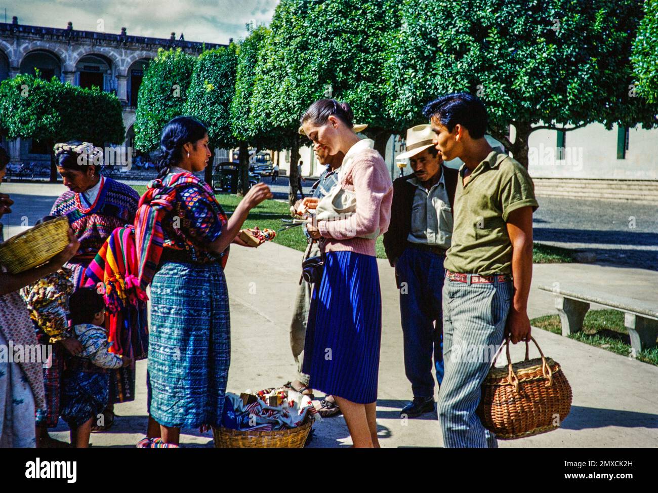 Woman tourist buying a souvenir from indigenous Mayan, street trader ...