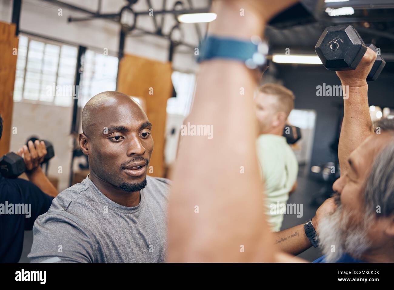 Gym, old man and help from personal trainer with dumbbell weightlifting ...