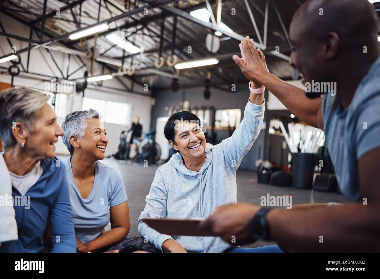 Senior women, fitness and personal trainer high five for health ...