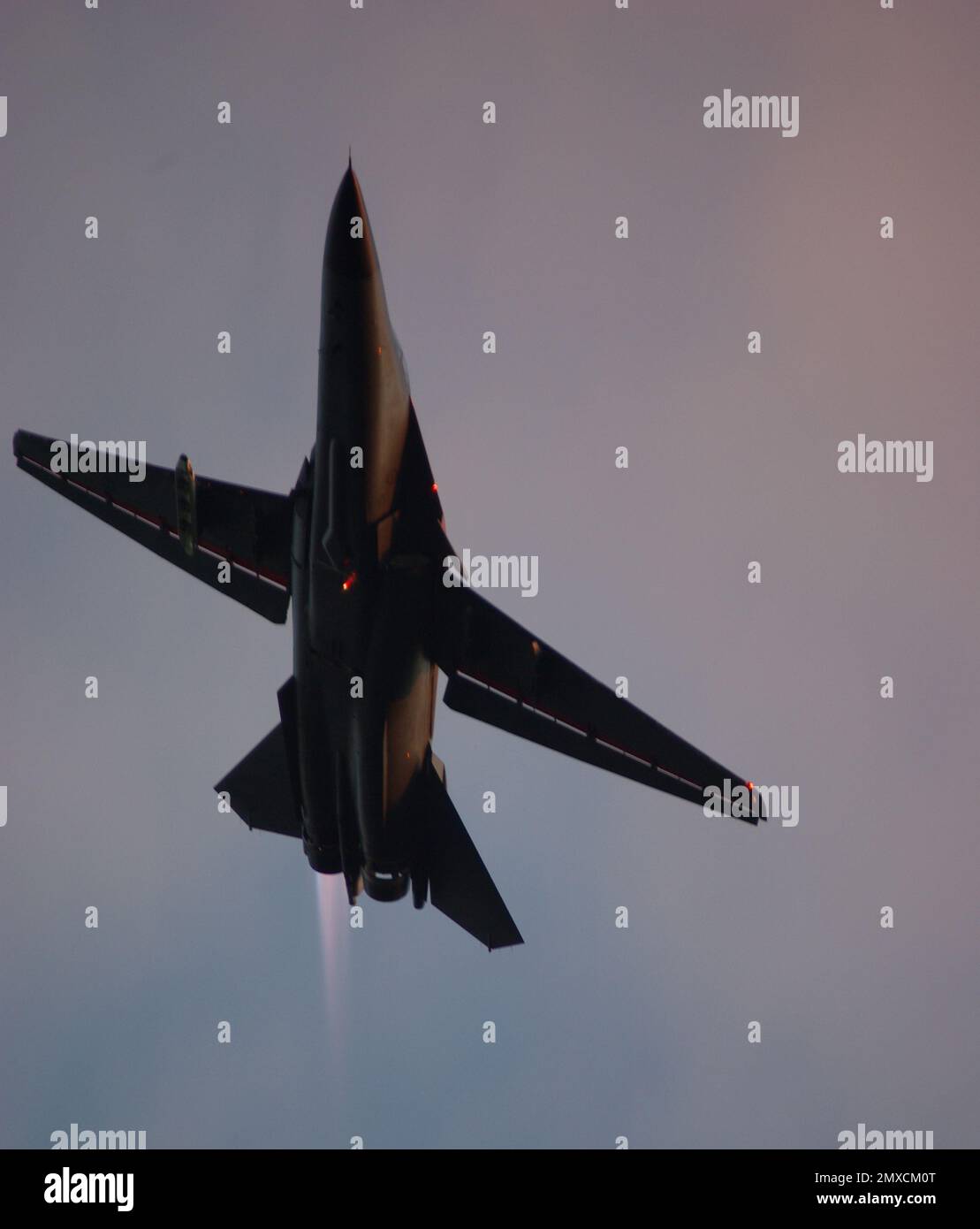 A military fighter jet flying in the sky Stock Photo - Alamy